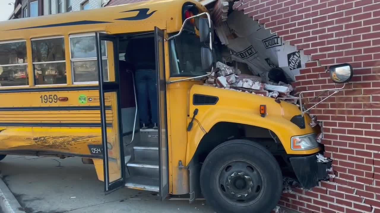 School bus crashes into building's only entrance, trapping people inside